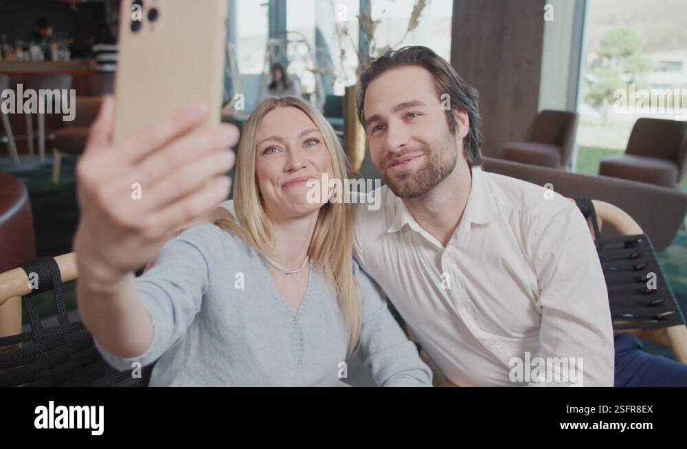 Smiling family couples talking on video using mobile phone calling from ...