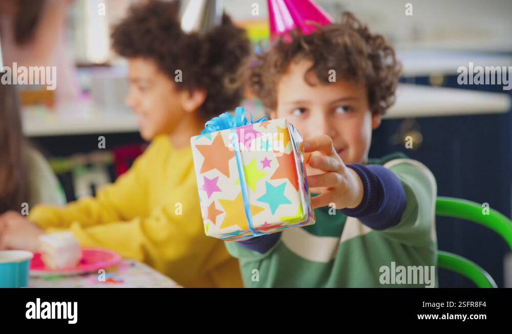 Boy Giving Gift At Birthday Party With Friends And Parents At Home ...