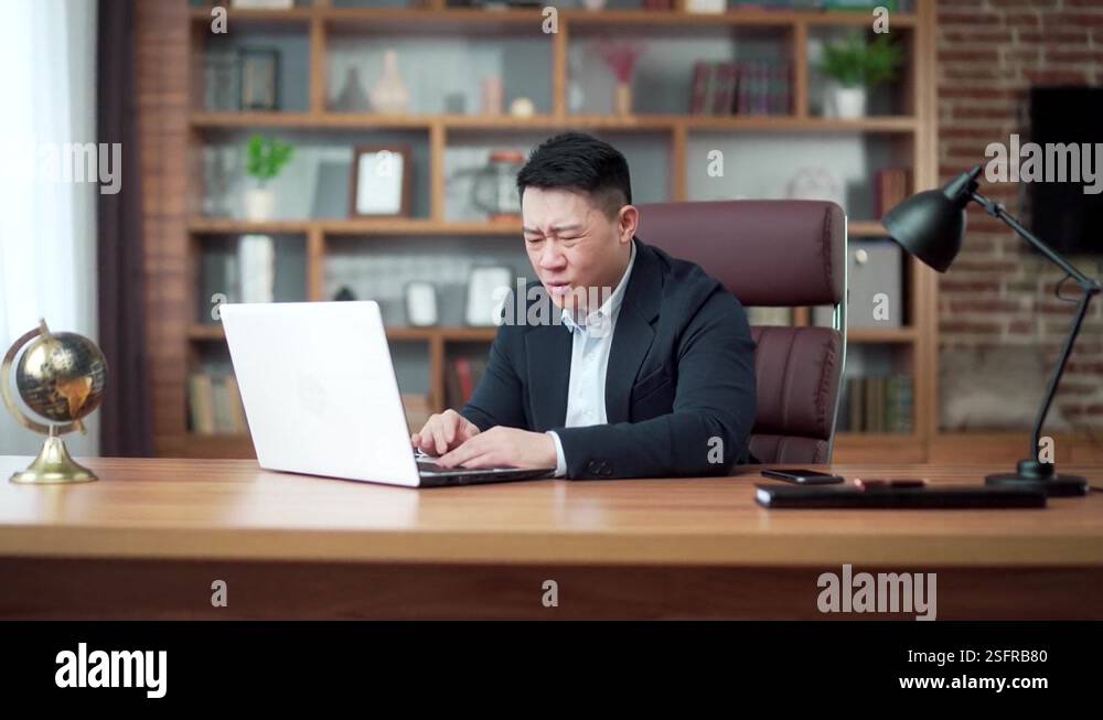 frustrated asian business man working at computer. Fail sitting at ...