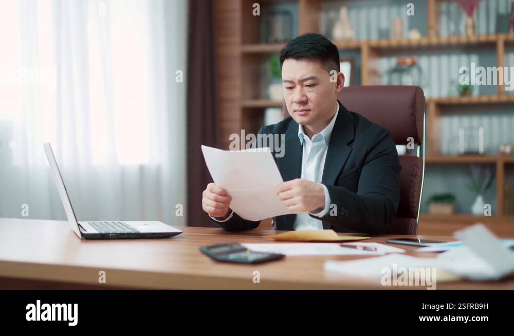 worried entrepreneur working and reading a letter with bad news ...