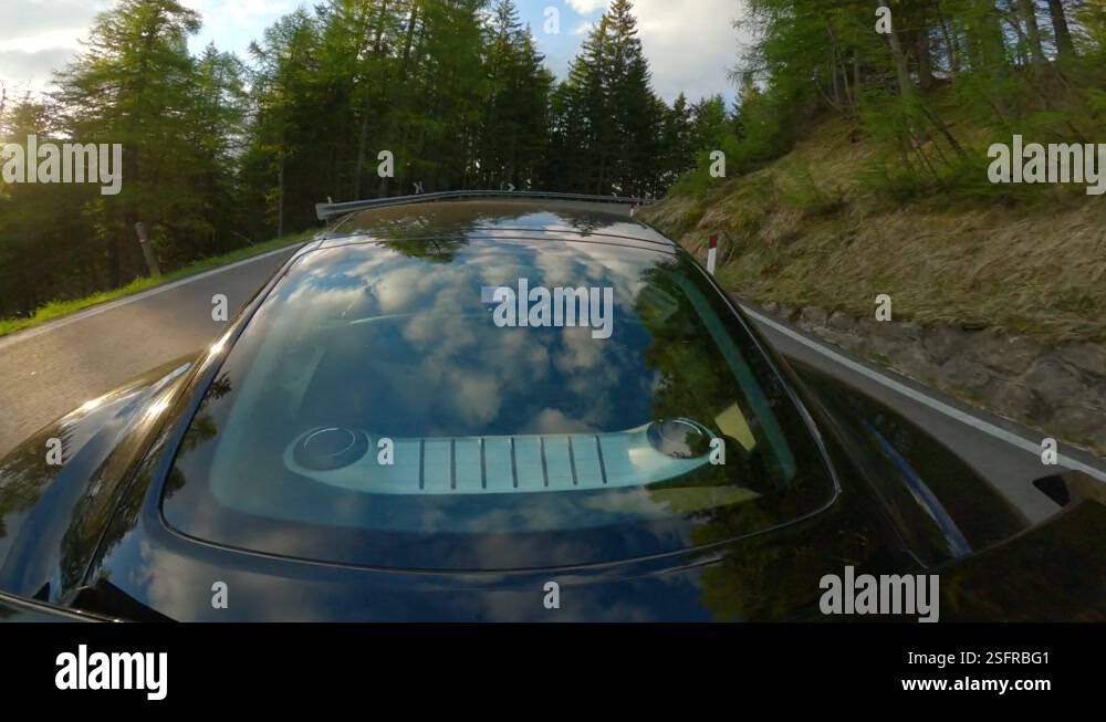 Panoramic drive on the alpine road through green forest with views of ...