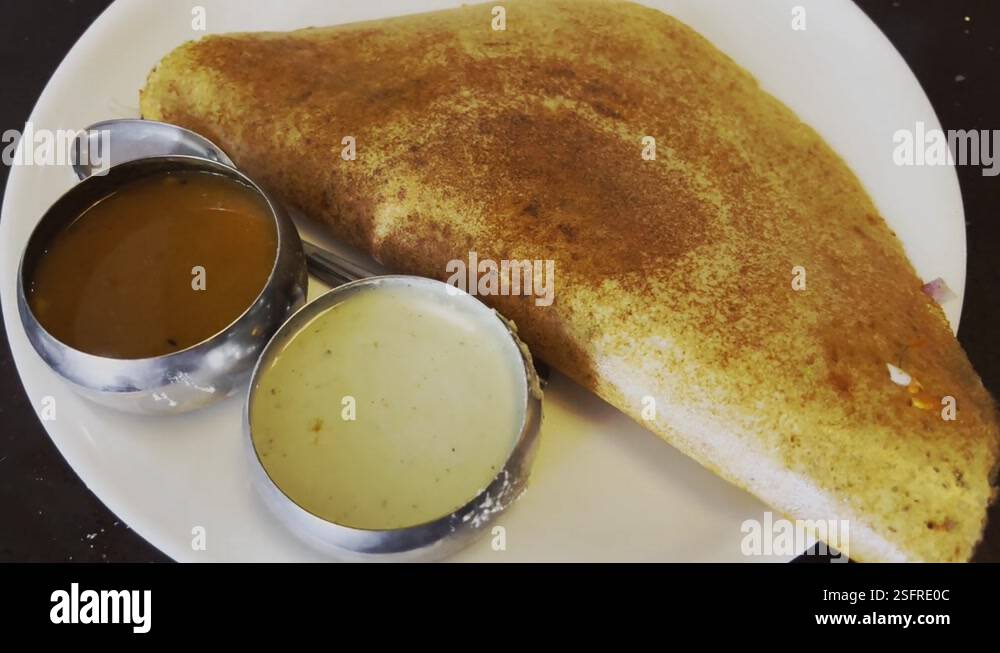 Top view of masala dosa which is a south Indian meal with sambhar and ...