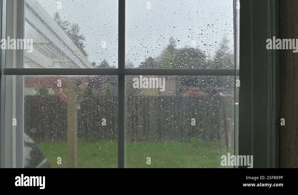 Rainy day outside. Looking out through window from dark room Stock ...