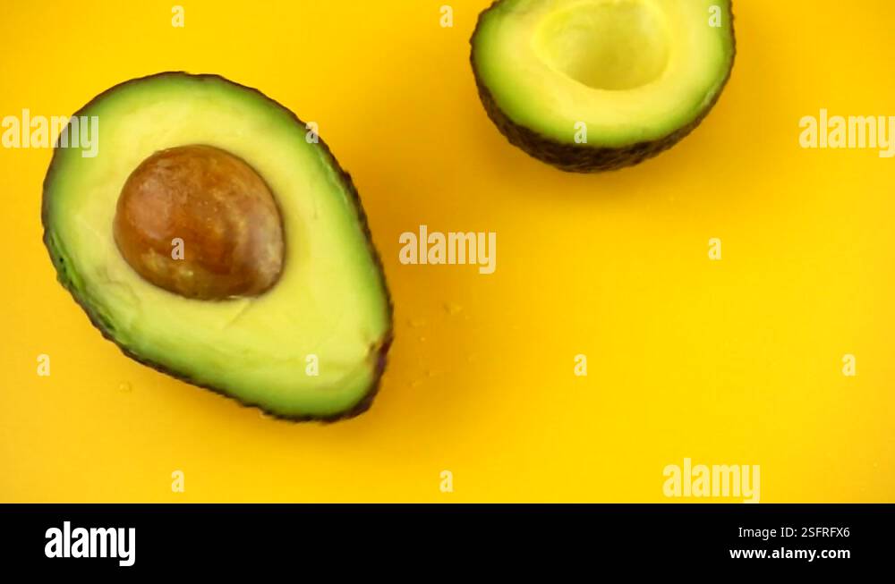 Rotating segments of a ripe and juicy avocado on an Stock Video Footage ...