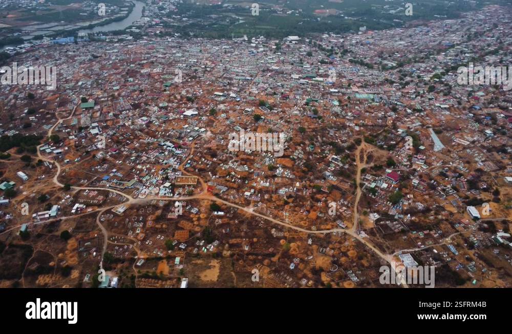 Huge and vast rural graveyard in asian city outskirts from above ...