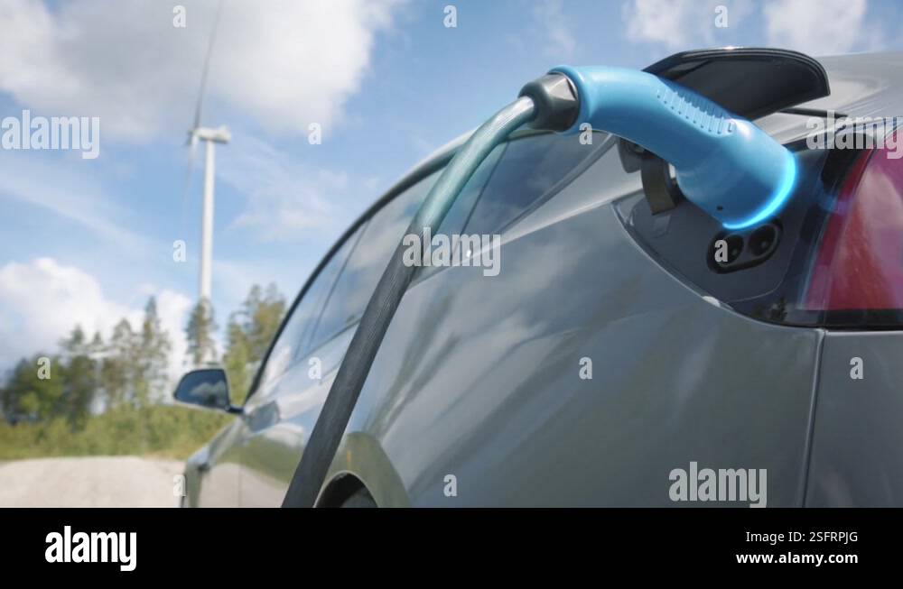 ZOOM IN, GRAPHICS ENHANCED - A generic electric car charges in front of ...