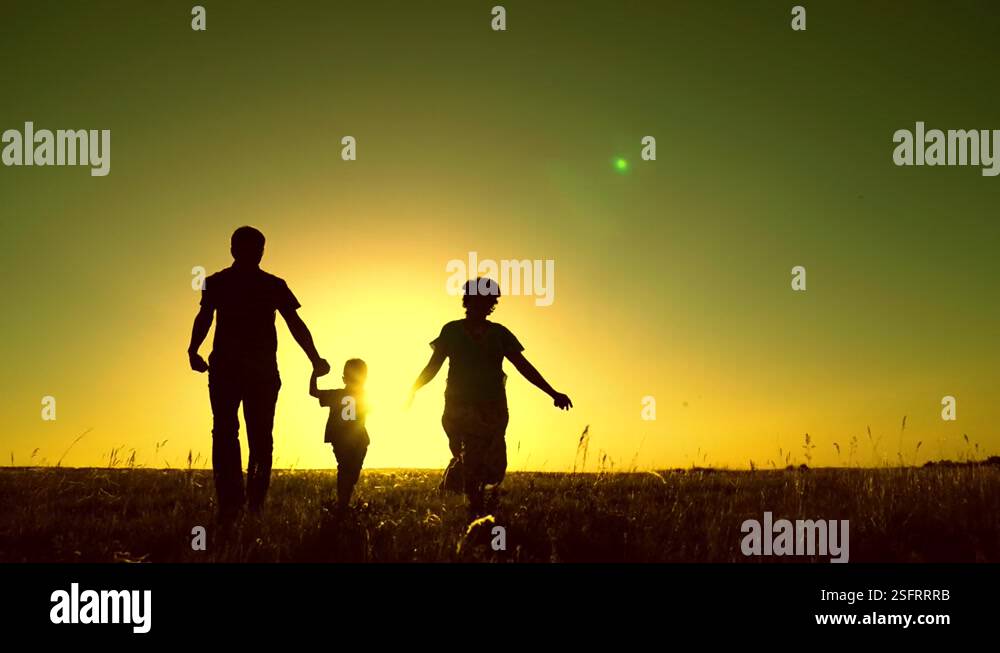 Mom dad son family walk. Happy family runs in park at sunset. Teamwork ...