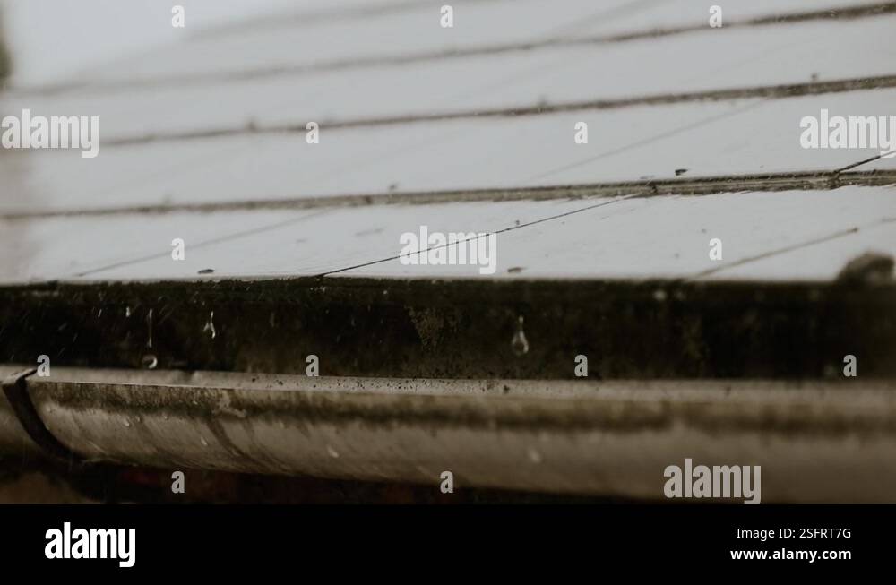 Heavy rain falling on garage rooftop into gutter Stock Video Footage ...