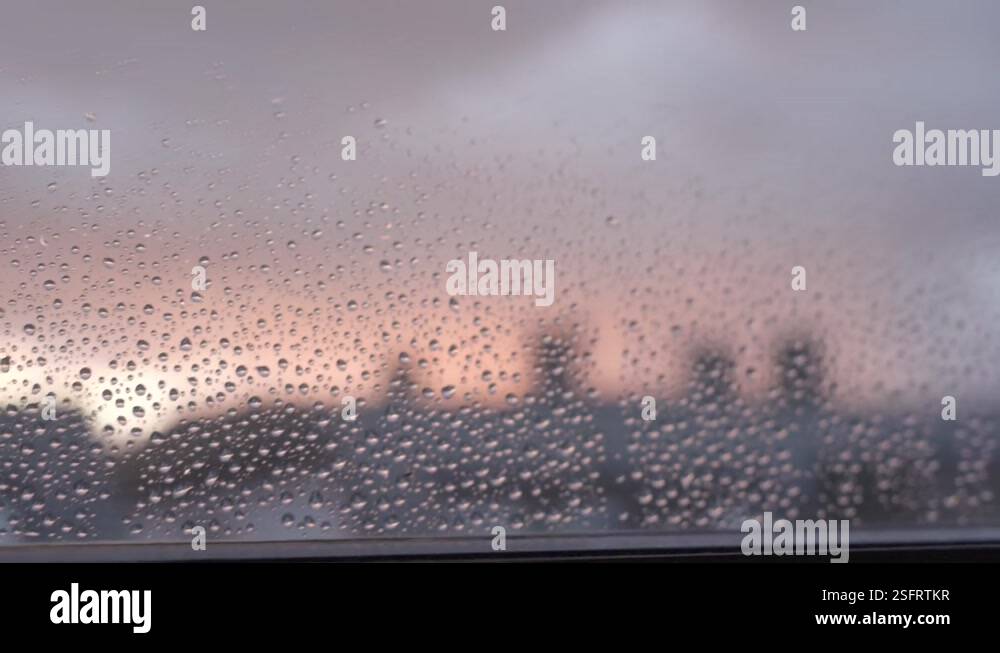Rain drops on the window after the storm. Beautiful sunset in the Stock ...