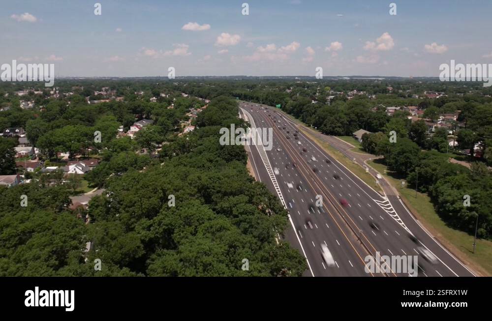 An aerial time lapse of a highway. It is a high angle shot showing the ...