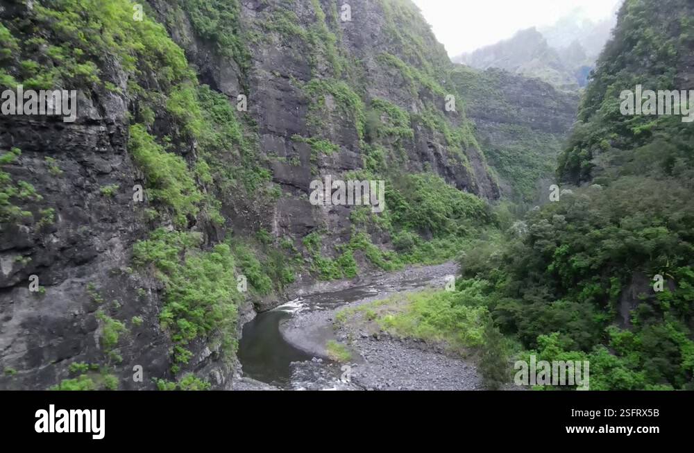 Drone footage of a river in a deep jungle canyon in the Cirque of ...