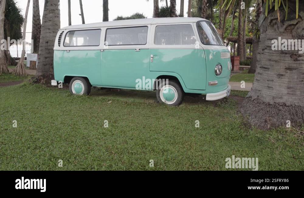 A tilt reveal of a beautifully restored classic Volkswagen Van parked ...
