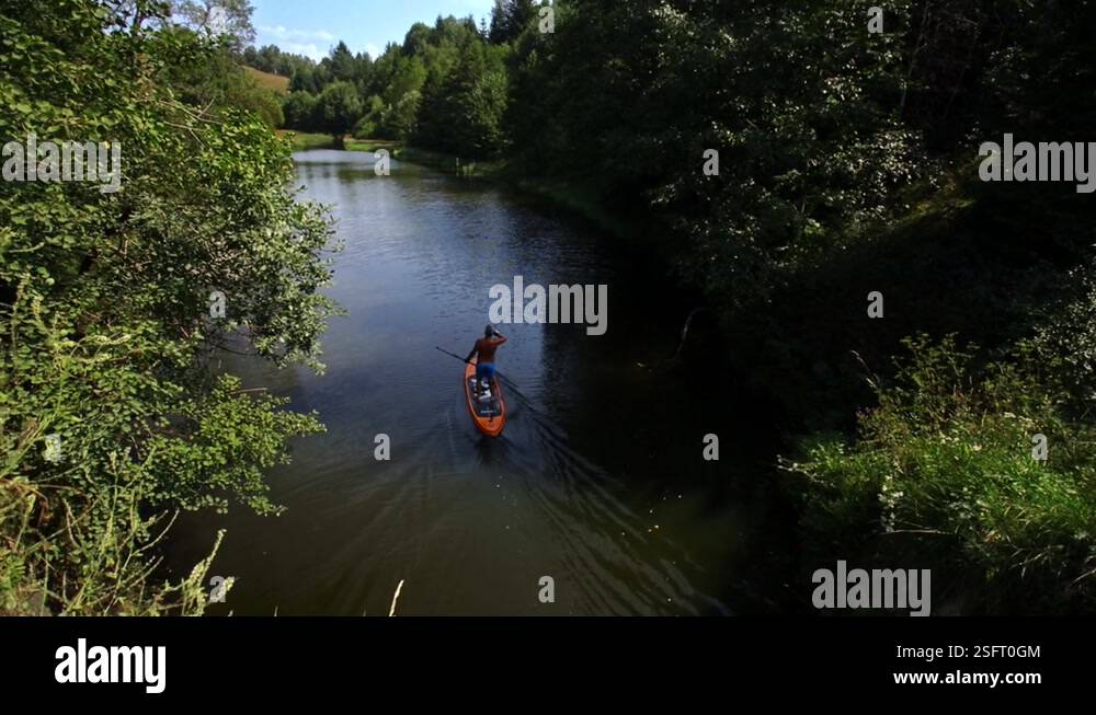 Man with pagaia, runs along the river 1 Stock Video Footage - Alamy