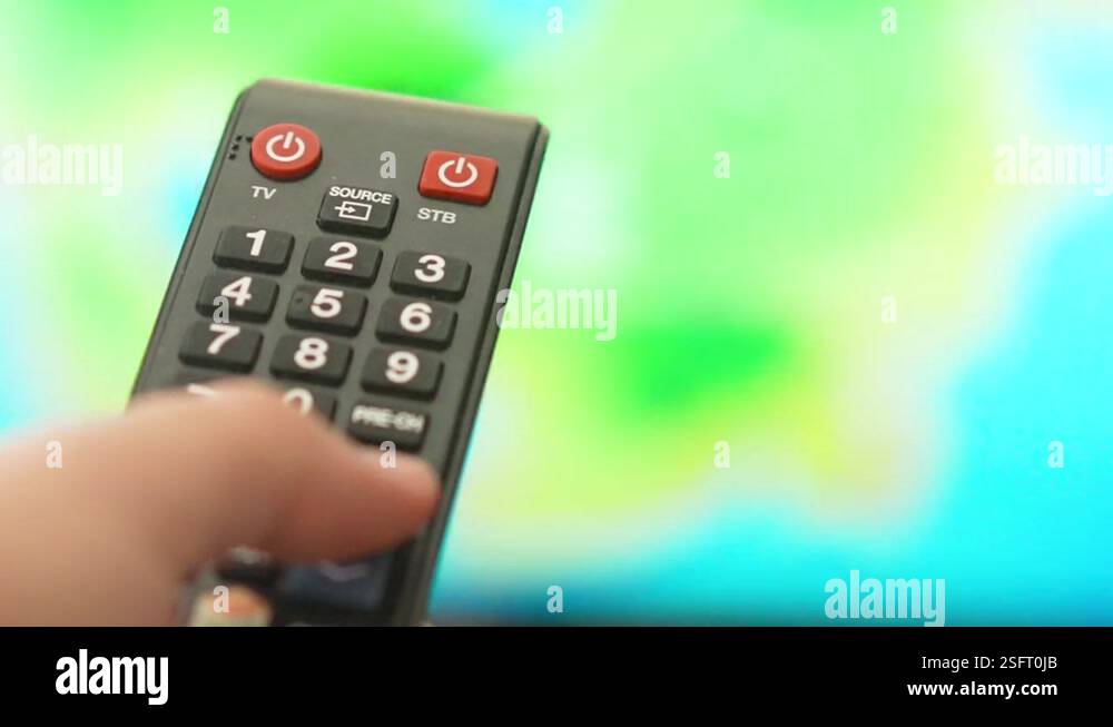 Changing channels on television with remote control extreme close-up ...