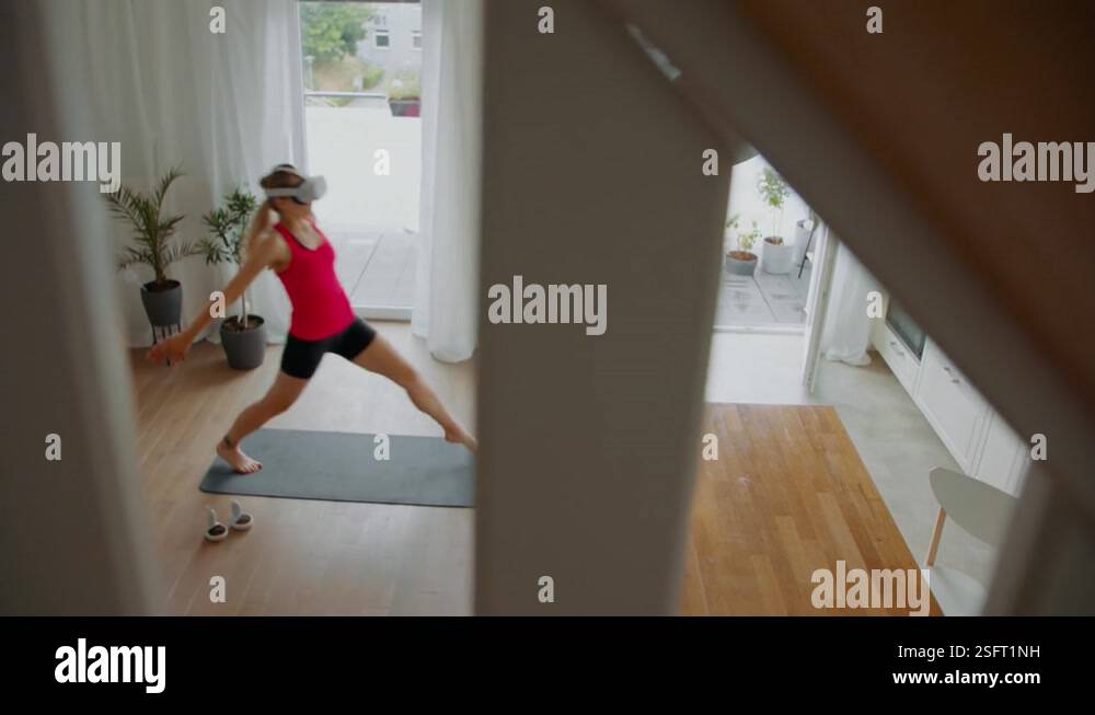 Fit mid 30s Caucasian female performing yoga stretching workout in ...