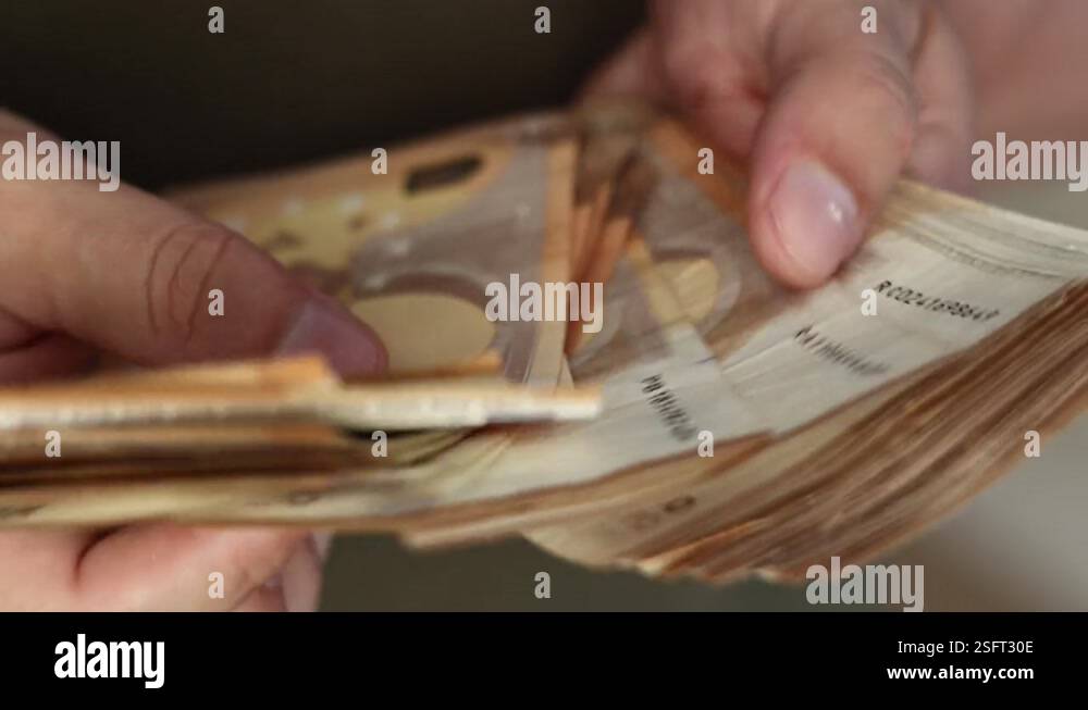 Man Counting Money. Close up of male hands counting big pile of 50 euro ...