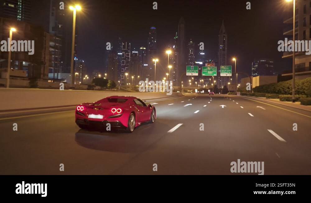 Rolling shot of Red Ferrari F8 Tributo supercar driving at night in ...