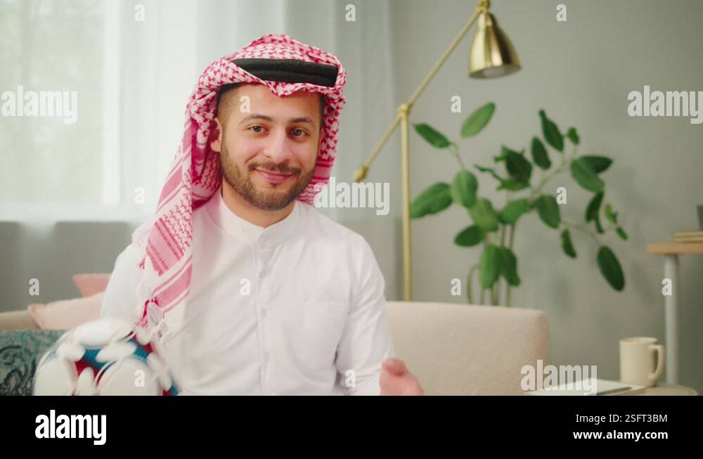 Middle eastern football fan portrait. Young man holding soccer ball ...