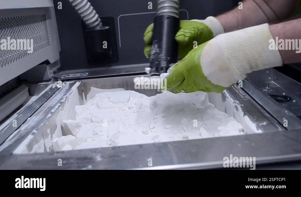 Engineer or artist designer printing 3D parts, shaping models from dust ...