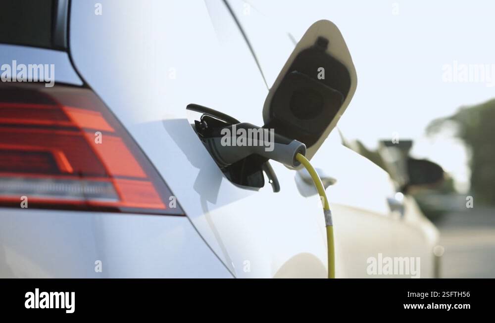 Electric car charging. Electric vehicle charging port plugging in car ...