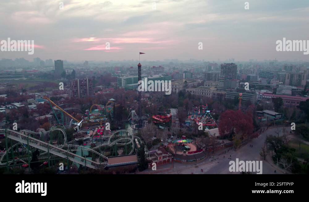 Aerial parallax revealing O'Higgins theme park in middle of cityscape ...