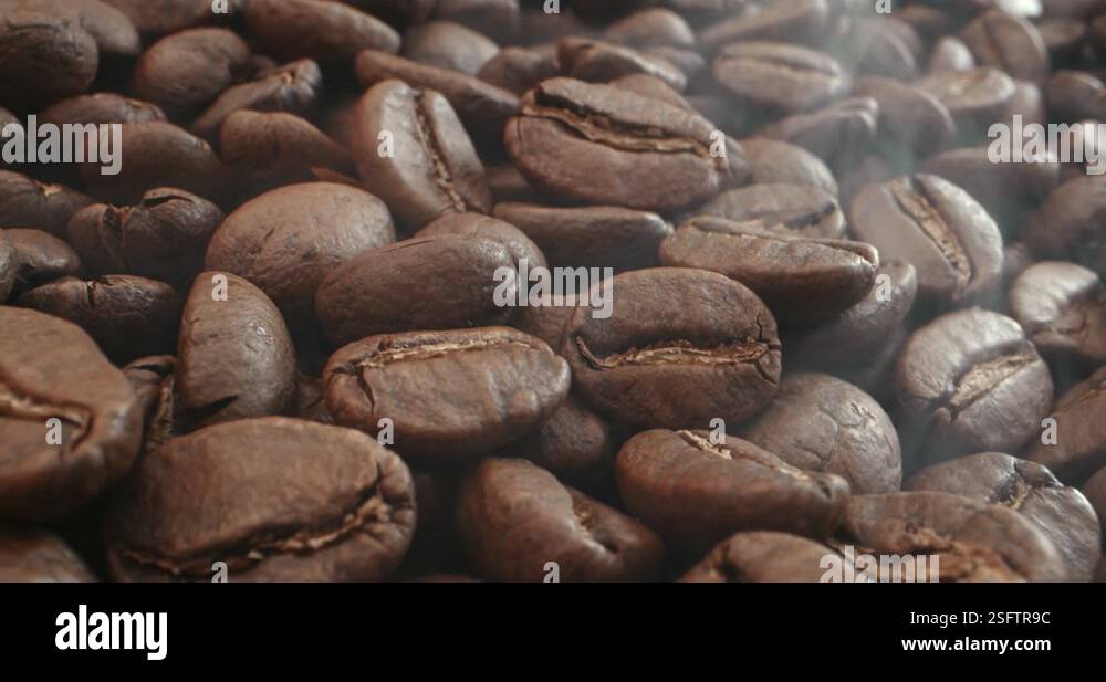Fragrant coffee beans are roasted smoke comes from coffee beans. Shot ...