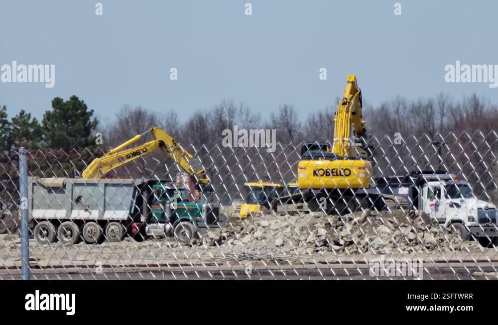Excavator is loading a truck with ground on building site Stock Video ...