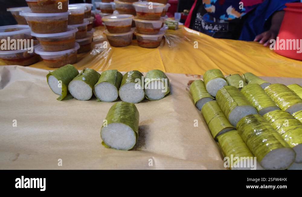 No recognize faces but with hands displaying rice rolls at the market ...