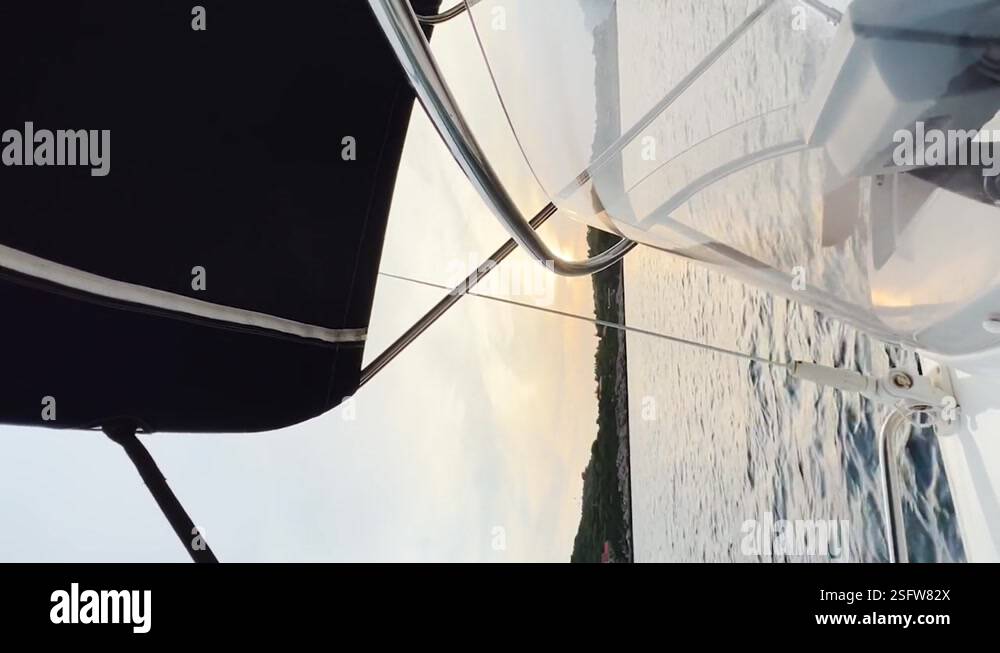 Side view from the speedboat while the sun sets behind the island in ...