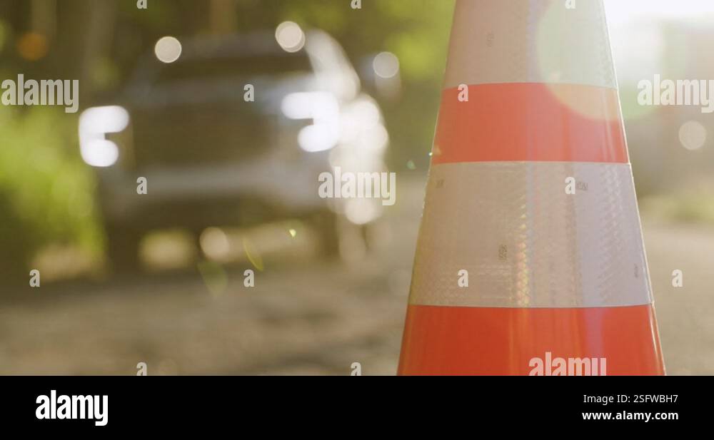Car Slowly Driving Along Road with Construction Traffic Cone Stock ...