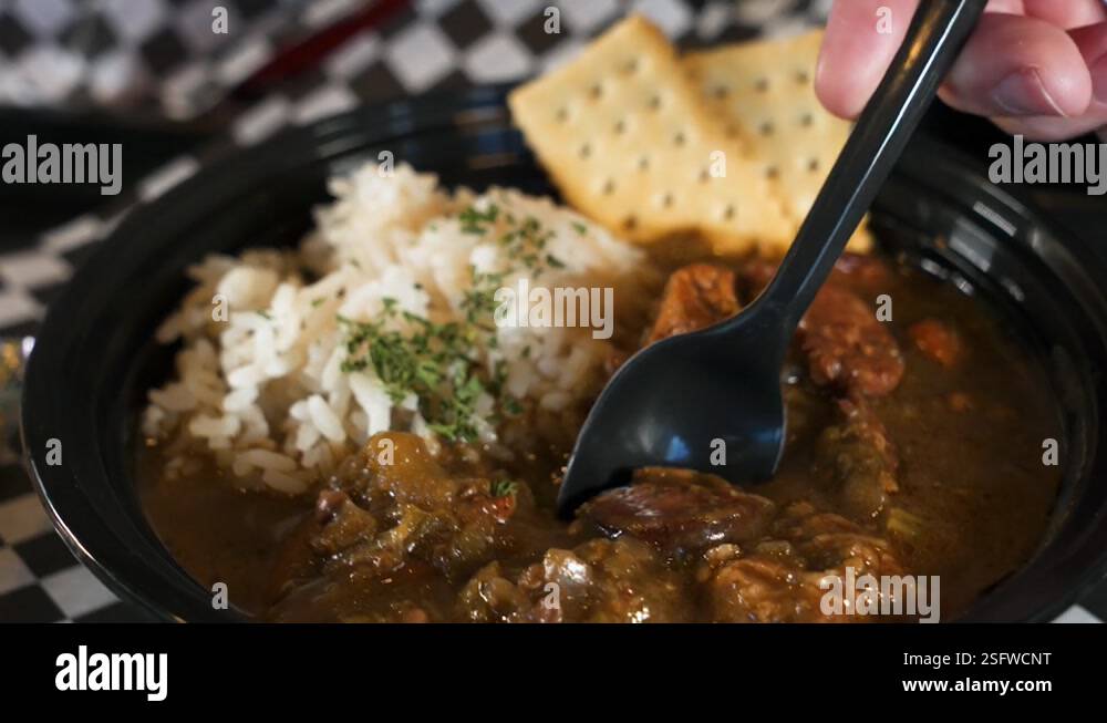 Spoonful of tasty cajun chicken and sausage gumbo, slow motion slider ...