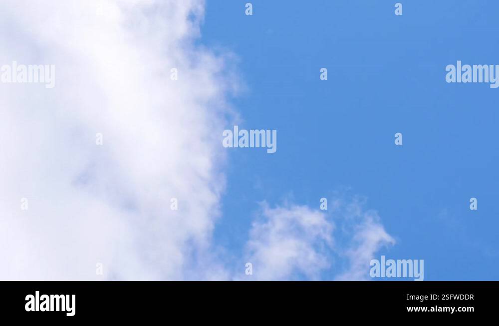 White clouds are flying across the blue sky. Timelapse Stock Video ...