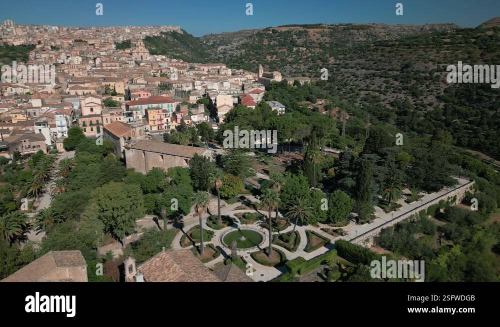 sunny flying counter clockwise around garden park of Ragusa Ibla in ...