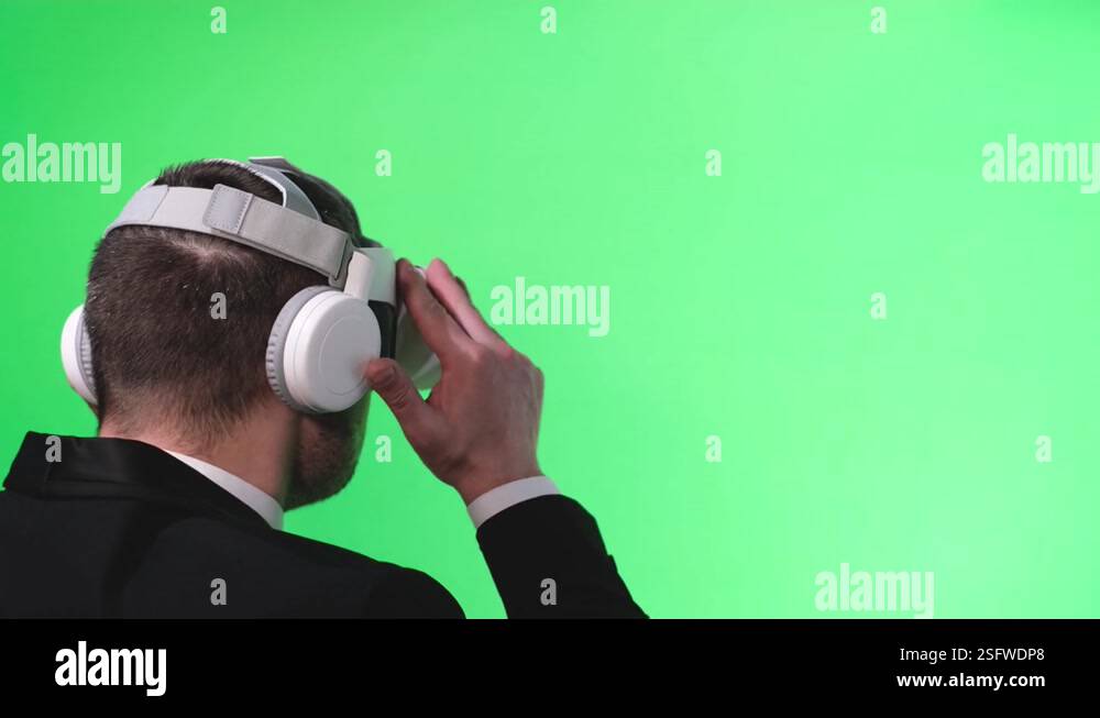 Man in business suit with virtual reality glasses on chromakey ...