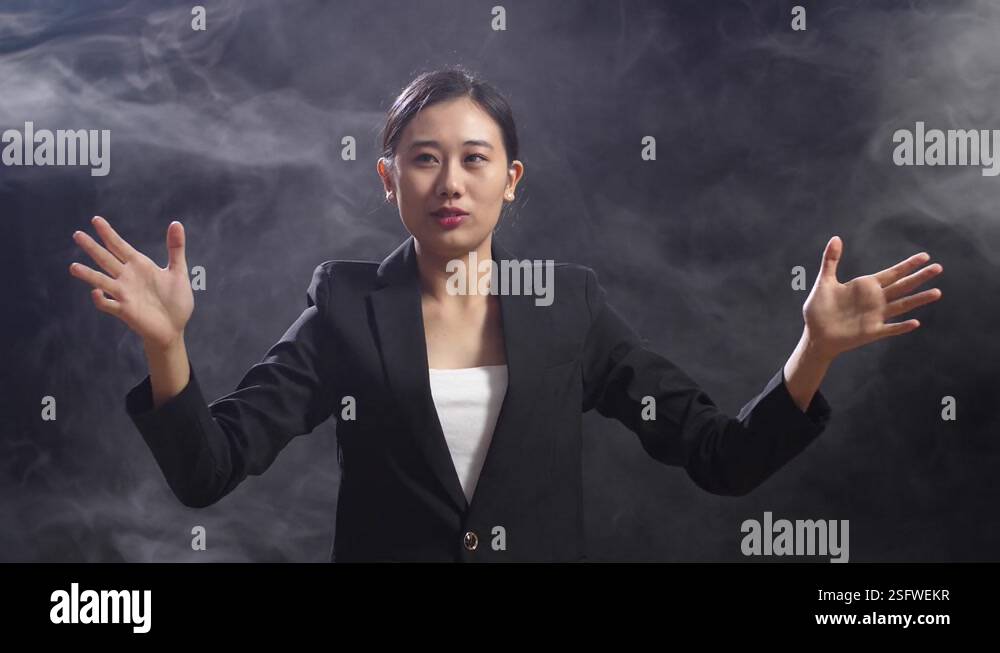 Asian Speaker Woman In Business Suit Holding Her Hands Together While ...