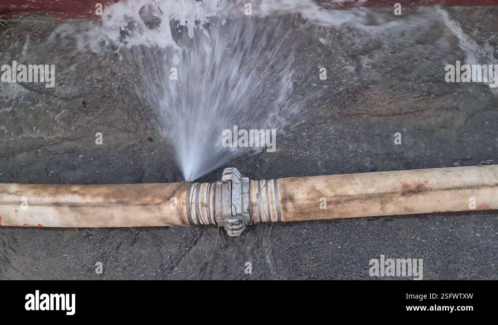 Expired Fire Hose, water leaking from joint Stock Video Footage - Alamy