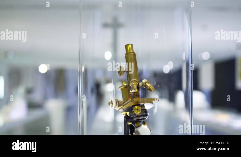 Pan down to an ancient microscope model made from brass, being ...