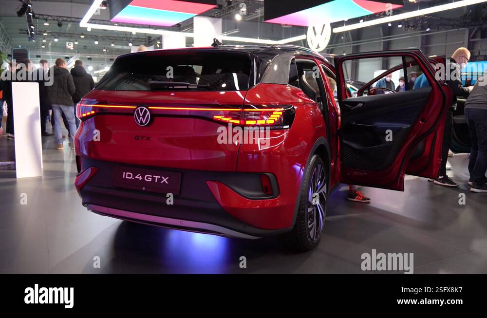 Red Volkswagen ID.4 GTX with open doors at a car exhibition - rear view ...