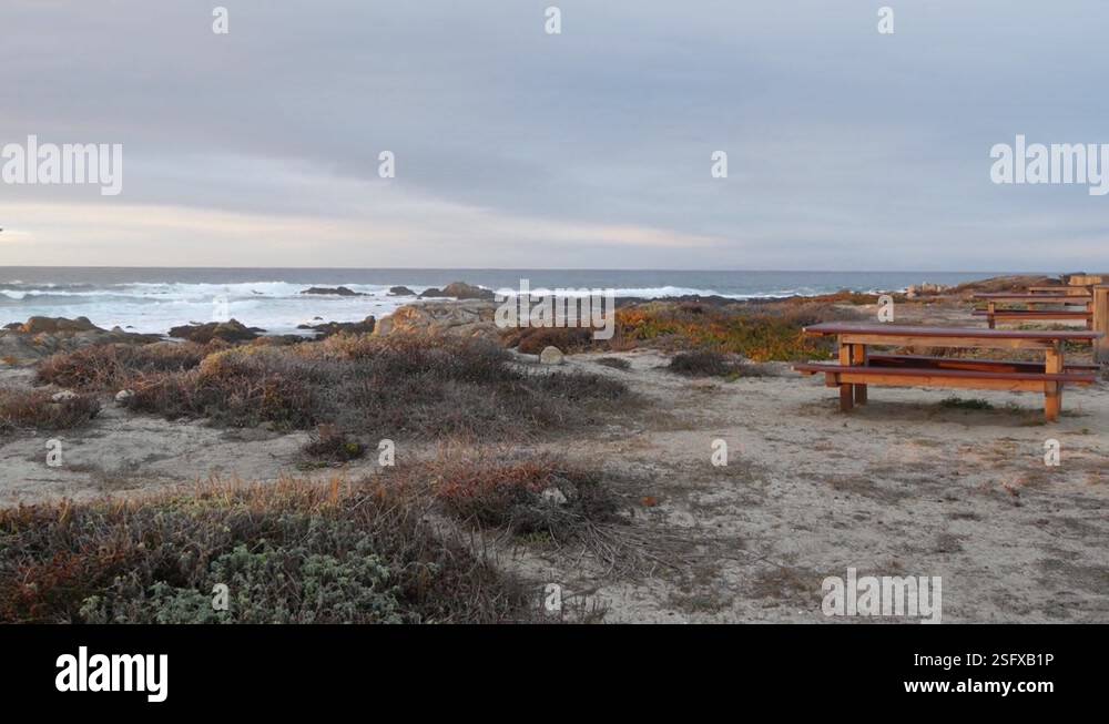 Rocky craggy ocean coast, sea waves, Monterey California. Wooden empty ...