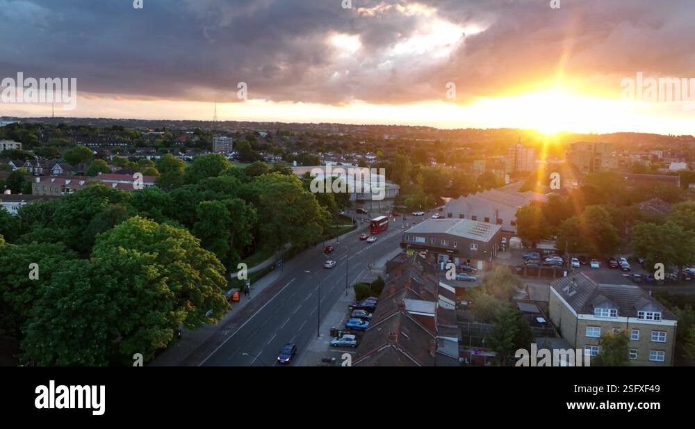 Romantic sunset over town, streets and buildings in residential ...