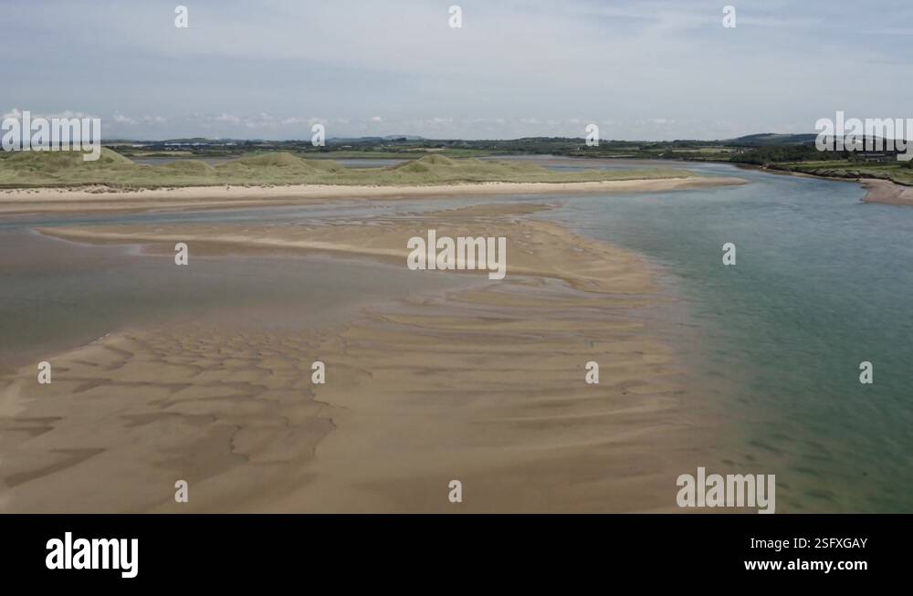 Large river sand bar revealed at low tide along Irish coast at Tramore ...