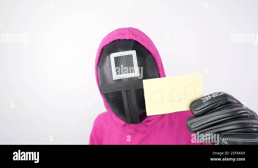 Squid Game pink guard shows the invitation card Stock Video Footage - Alamy