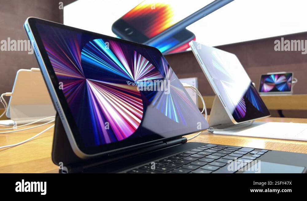 Apple Computers Store interior with row of new iPad Pro on magic ...
