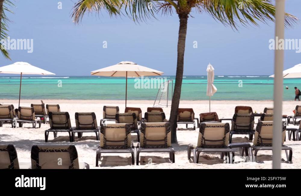 Caribbean resort beach scene. People relaxing with view of ocean and ...