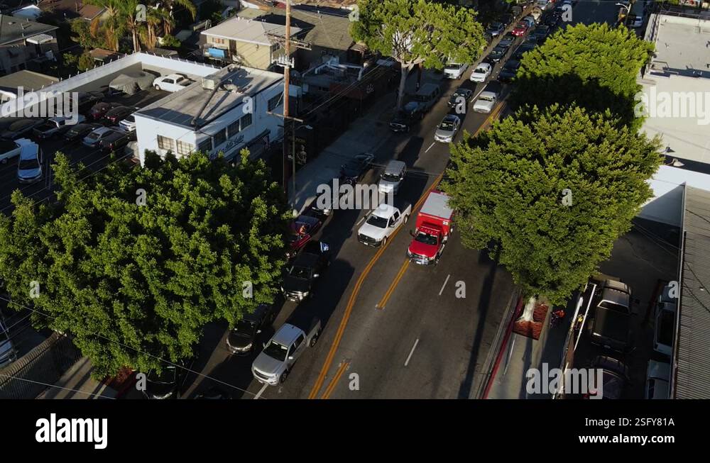 Aerial view around a Ambulance driving on the streets of sunny Los ...