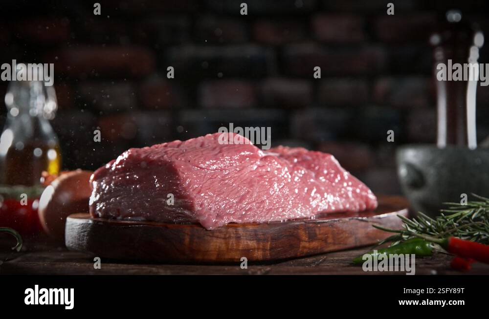 Flying piece of raw beef steak falling on cutting board Stock Video ...