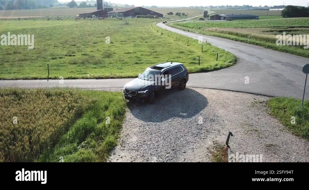 a volvo car backing up to get straight back on the road, drone shot ...