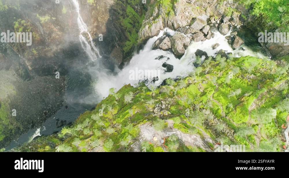 Spectacular Vøringsfossen waterfall plunge down lush rocky canyon ...