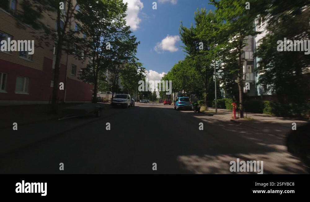 Dash POV of driving on small shaded tree lined residential street Stock ...