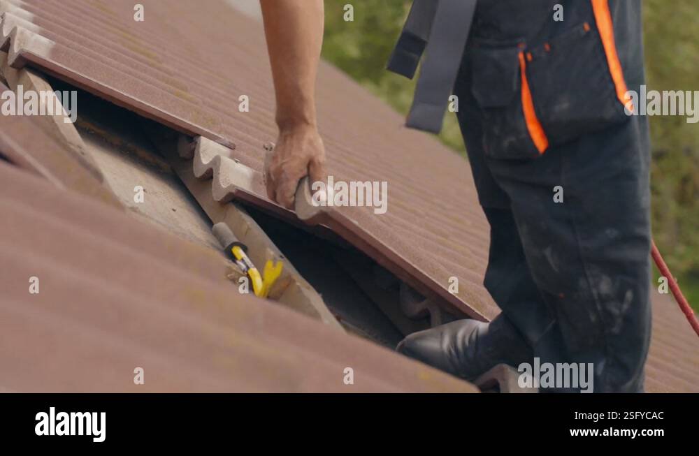 Roof tile removal, solar panel installation, PV installer working, day ...